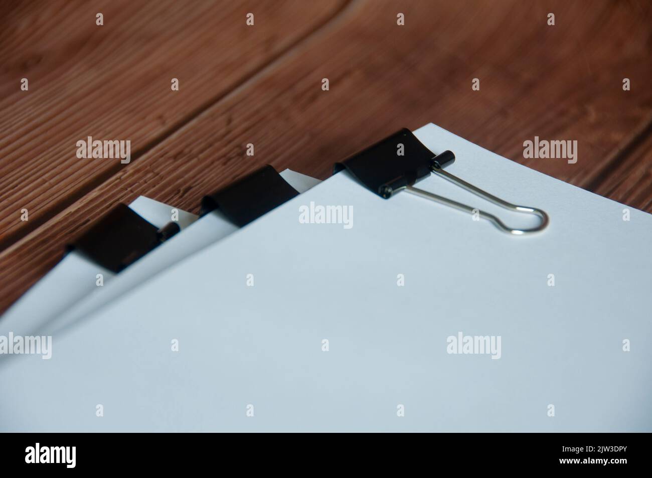 Paper stack of clipped pile of documents on wooden desk. Copy space and ...