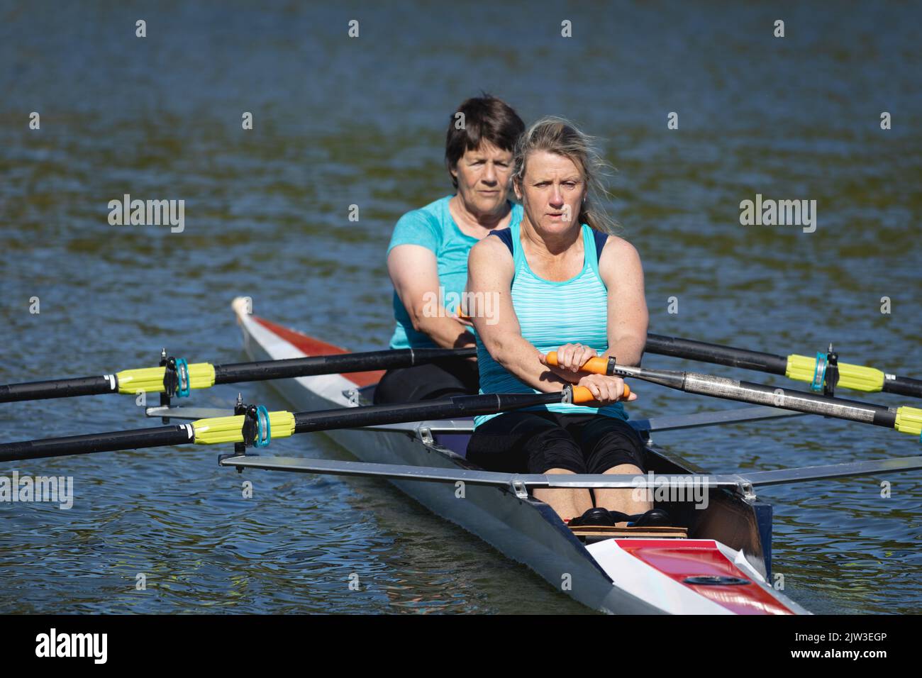 Two senior caucasian female rowers rowing the boat on the lake Stock ...