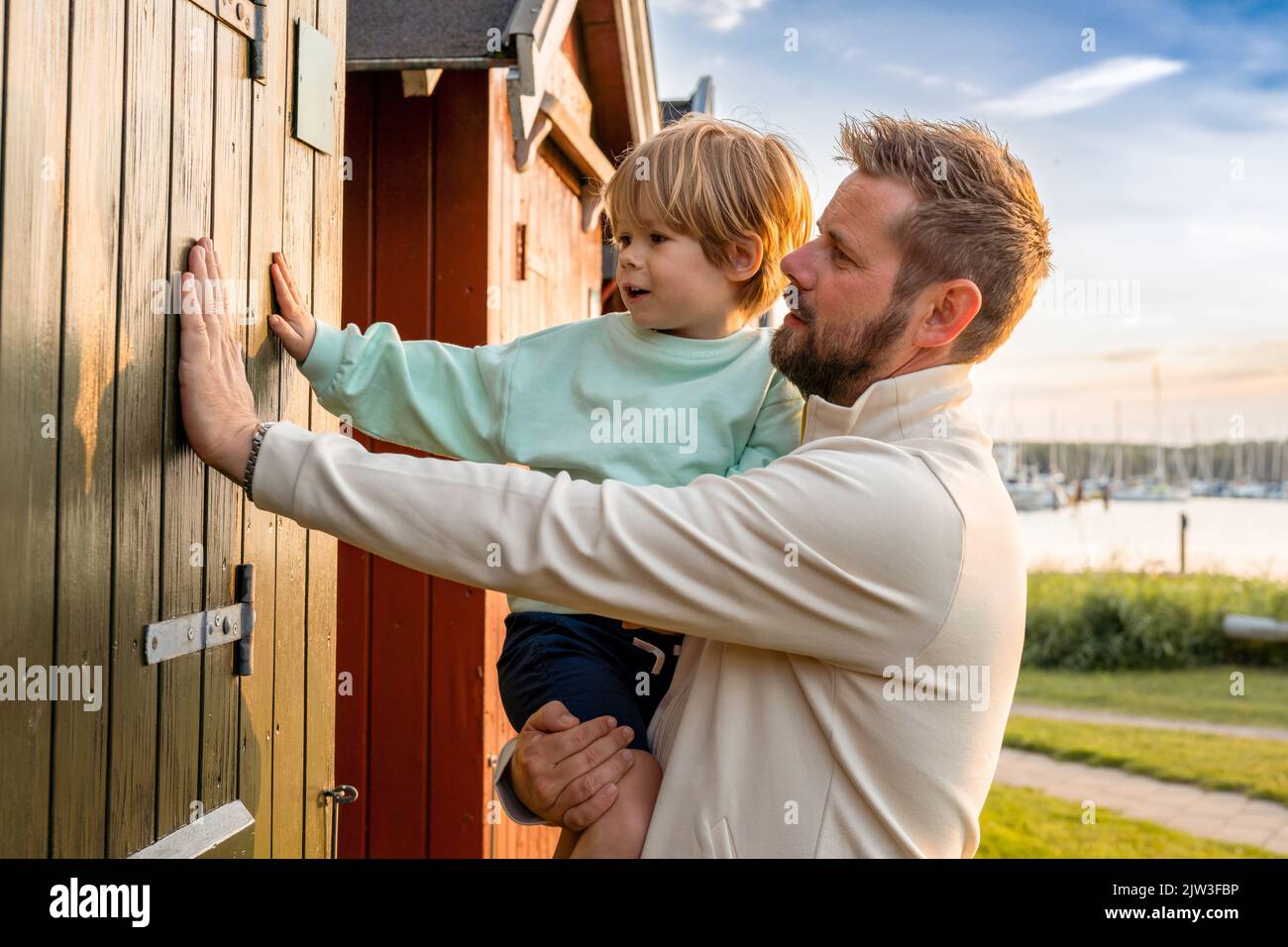 Portrait of a little boy bonding with his father outdoors Stock Photo ...