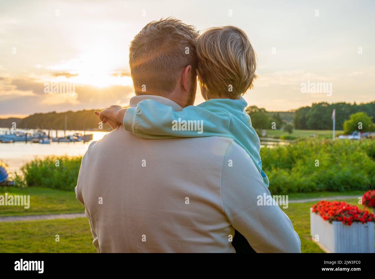 Back view of a shot of a father and his little son bonding together ...