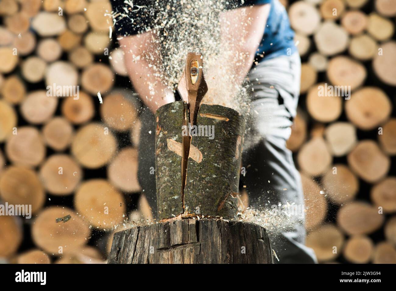 Hand and axe in firewood, chopping wood for fire heat Stock Photo - Alamy