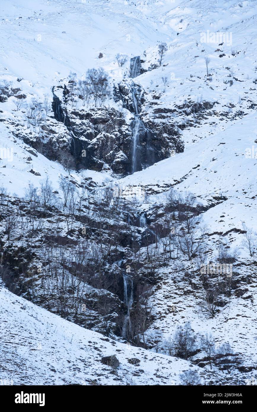 Beautiful Winter landscape image of waterfalls and trees on Stob Coire ...