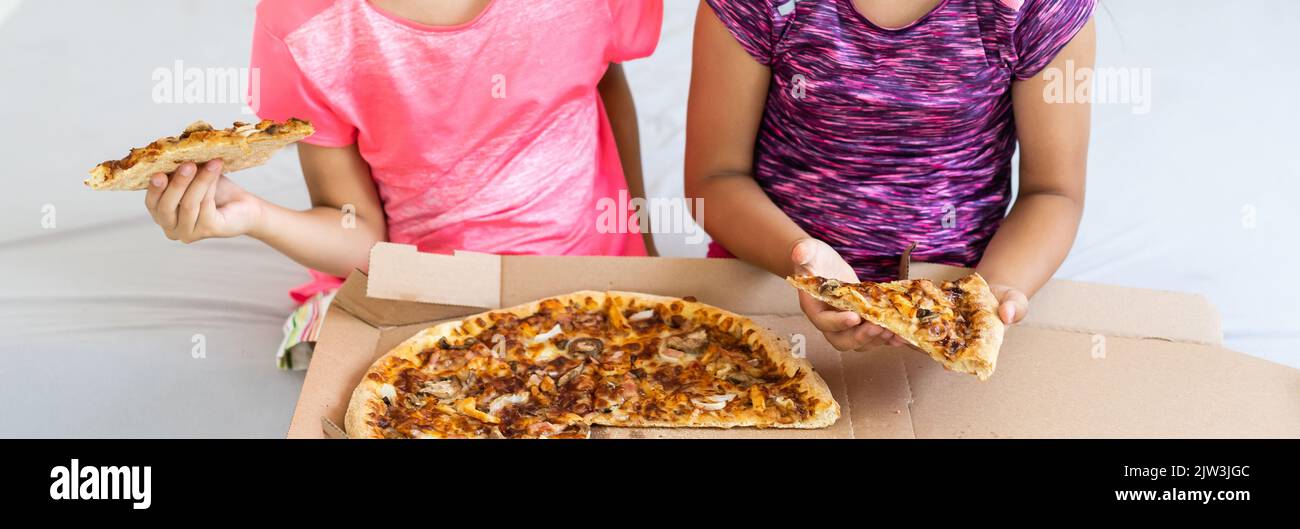 Happy children eating pizza and having fun together Stock Photo - Alamy