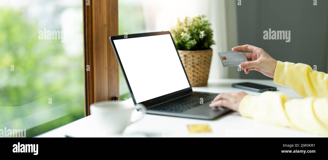 Online payment, Woman's hands holding credit card and using laptop ...