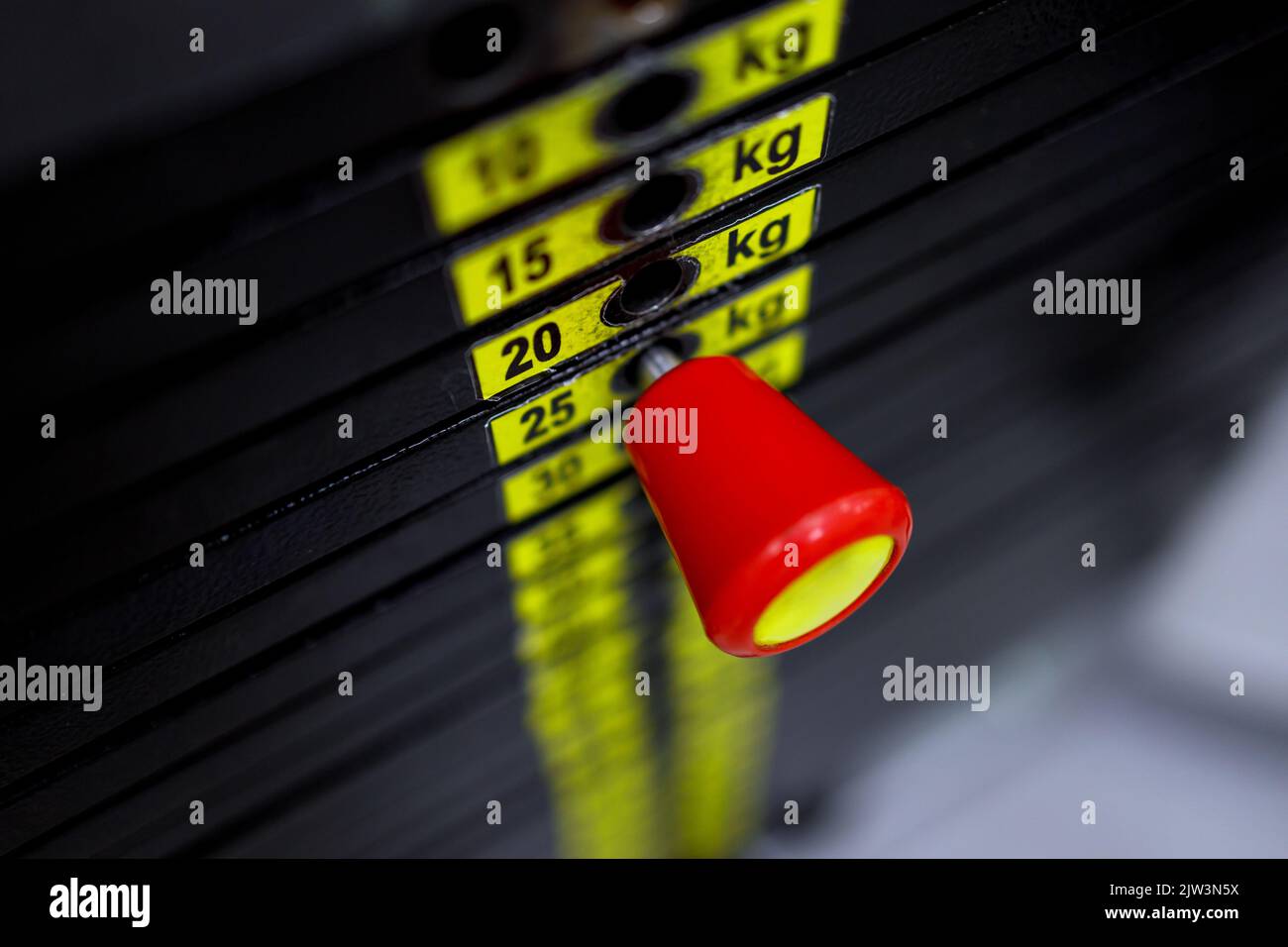 Numbers of weights on the gym machine for lifting Stock Photo - Alamy