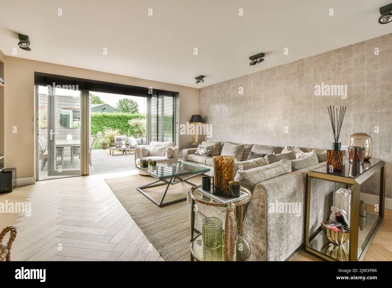 Couch and armchairs placed around table with decorations in dining area ...