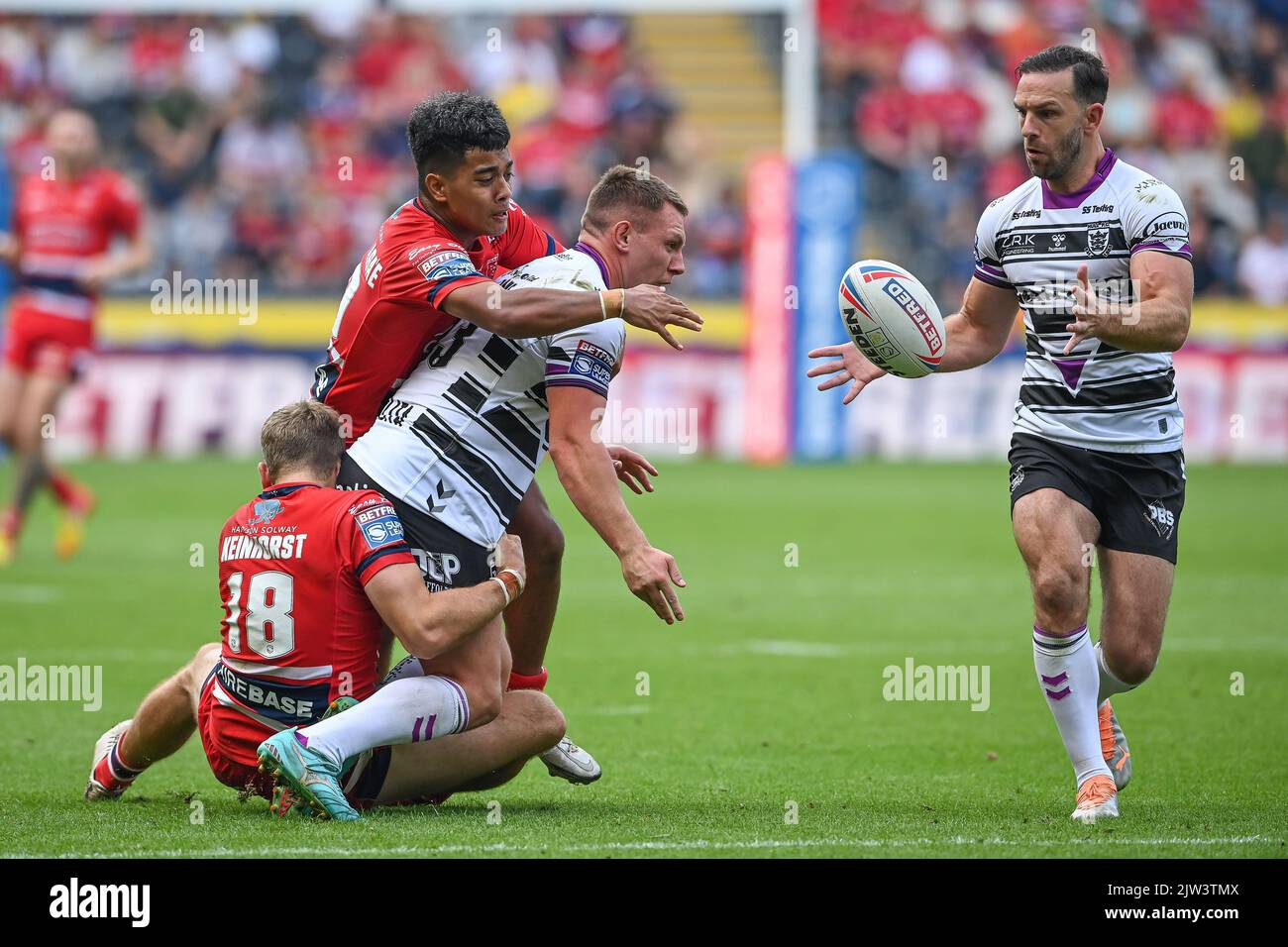 Jordan Lane #13 of Hull FC offloads to team mate Luke Gale #7 during ...