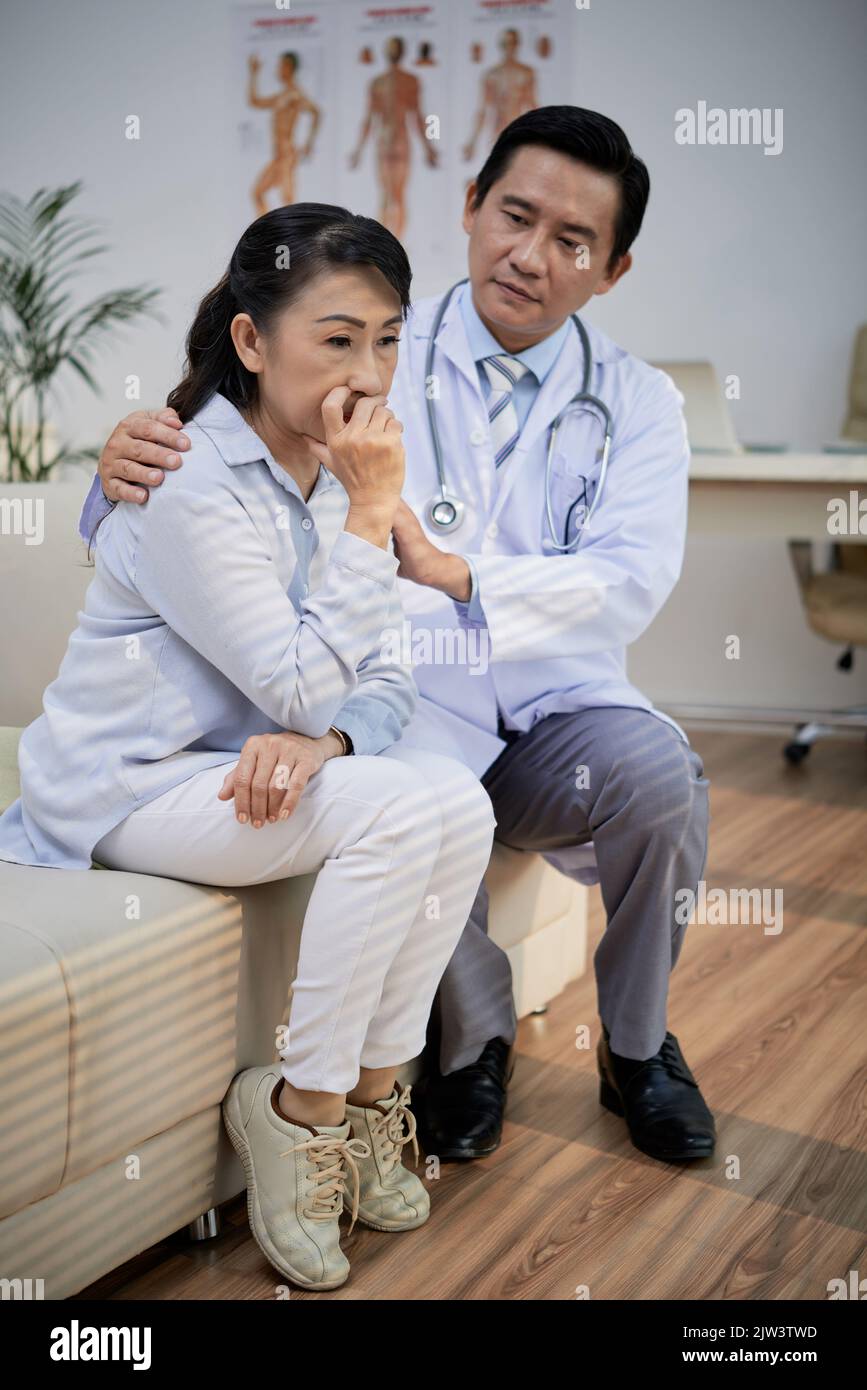 Doctor reassuring sad senior patient with dangerous diagnosis Stock ...