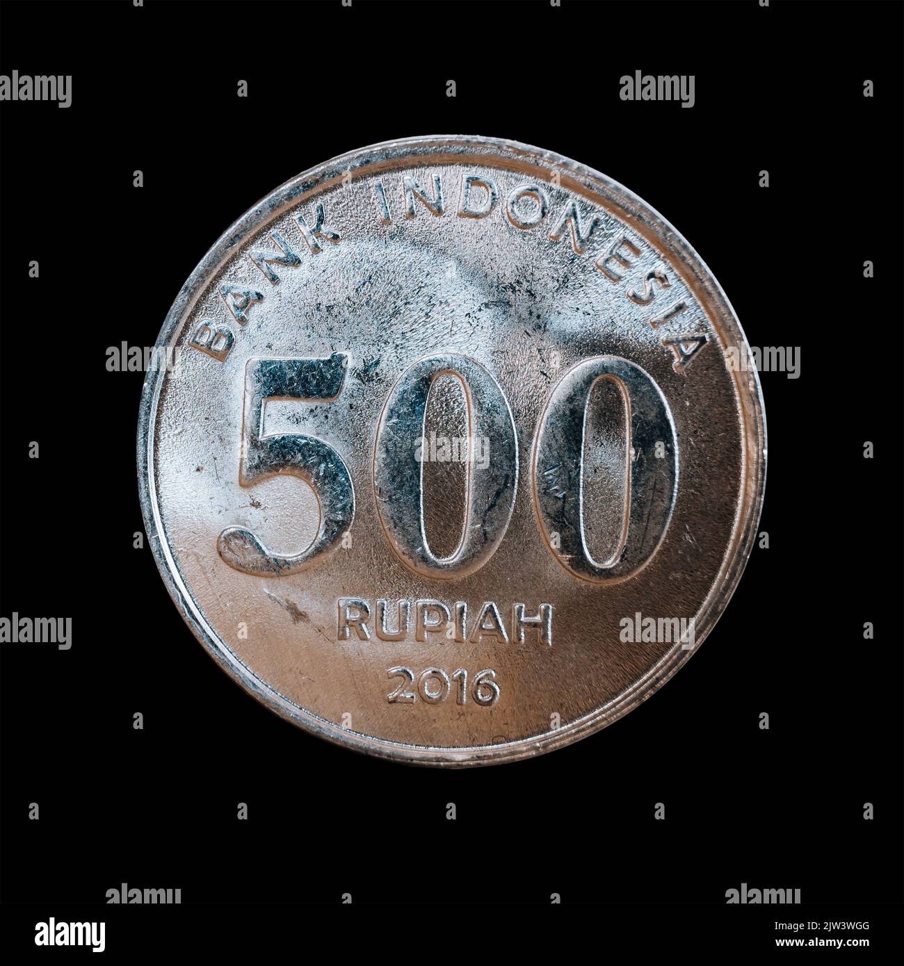 An old coin isolated on a black background Stock Photo - Alamy