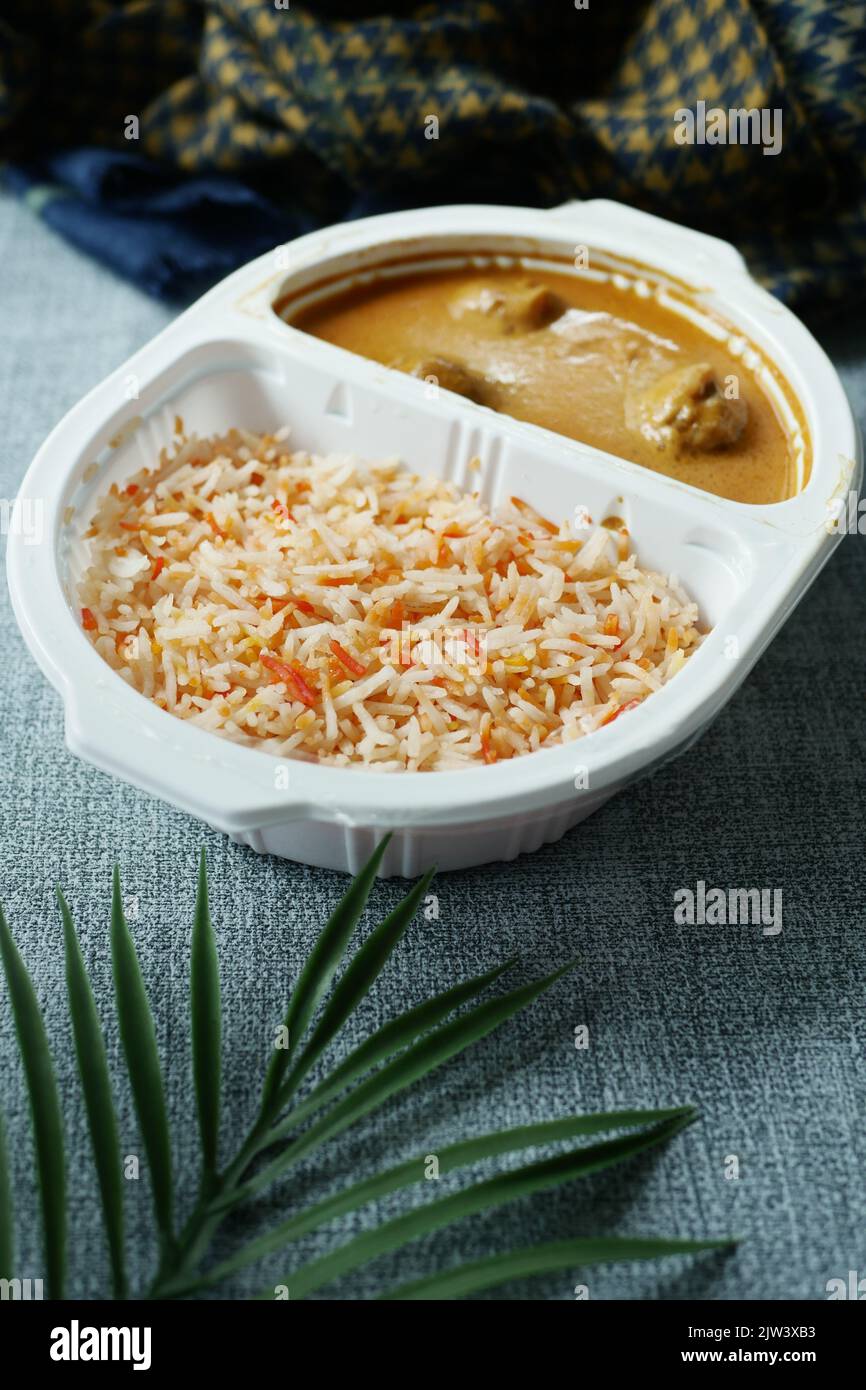 curry chicken and rice in a take away plastic packet on table Stock ...