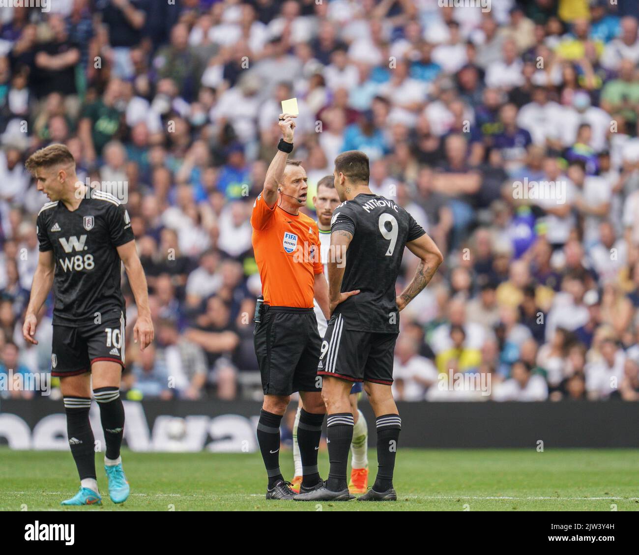 Referee Stuart Attwell gives Aleksandar Mitrović #9 of Fulham a yellow ...