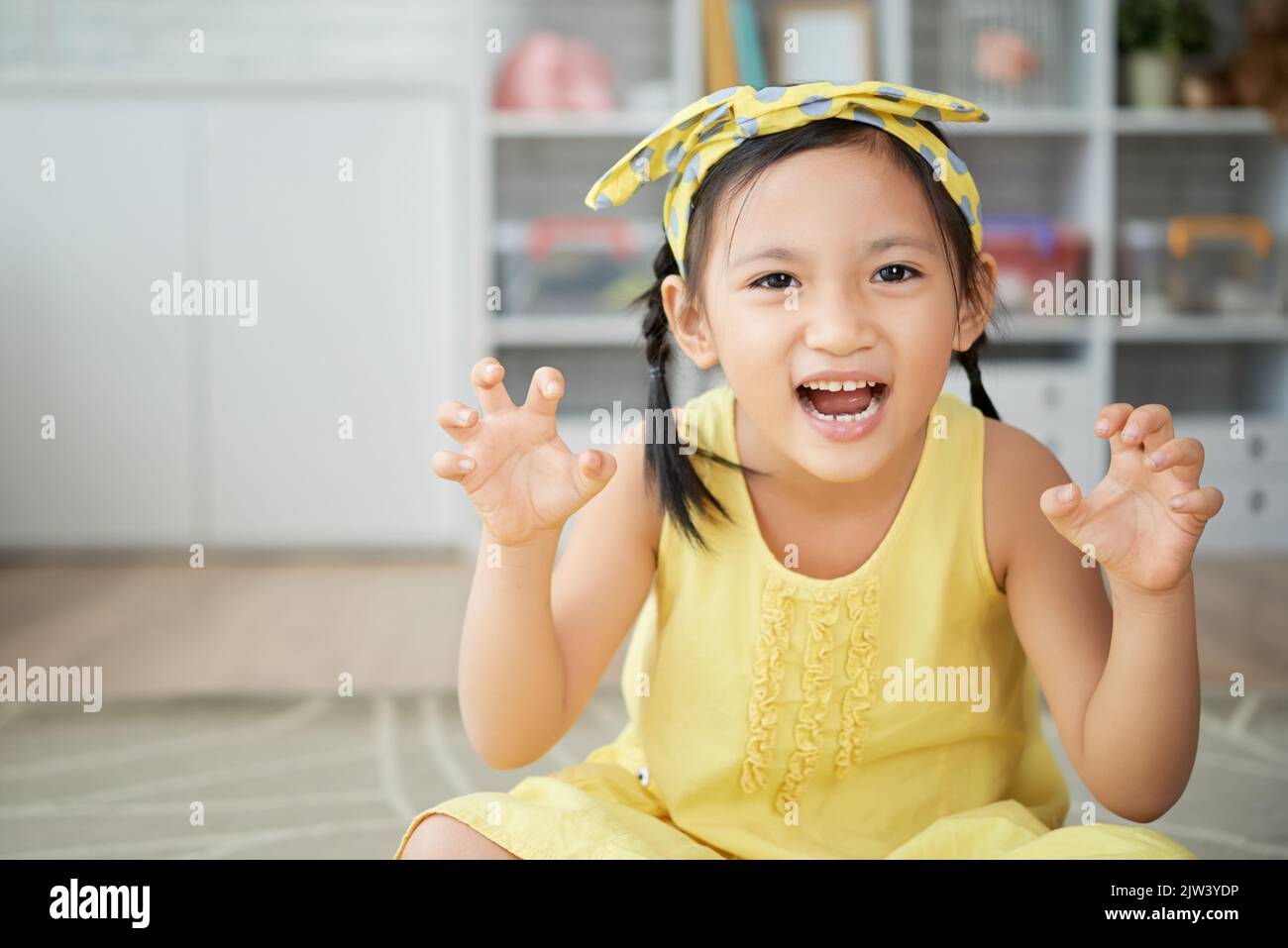 Sweet little Vietnamese girl making scary face Stock Photo - Alamy