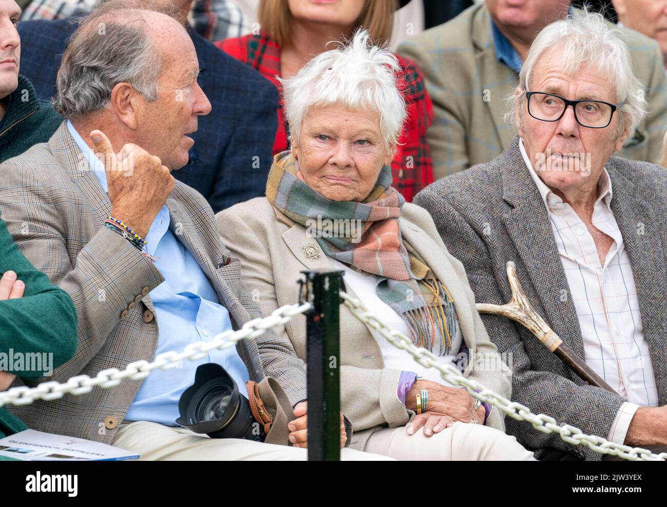 Dame Judi Dench and David Mills (right) watching the Braemar Royal ...