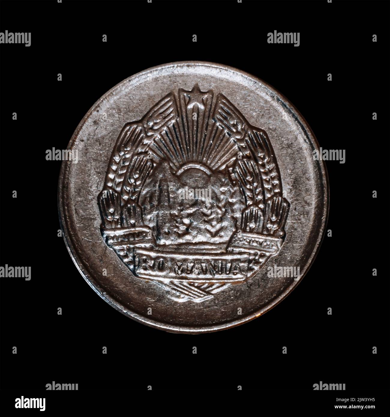 A view of a Romanian five Bani coin isolated on a black background ...