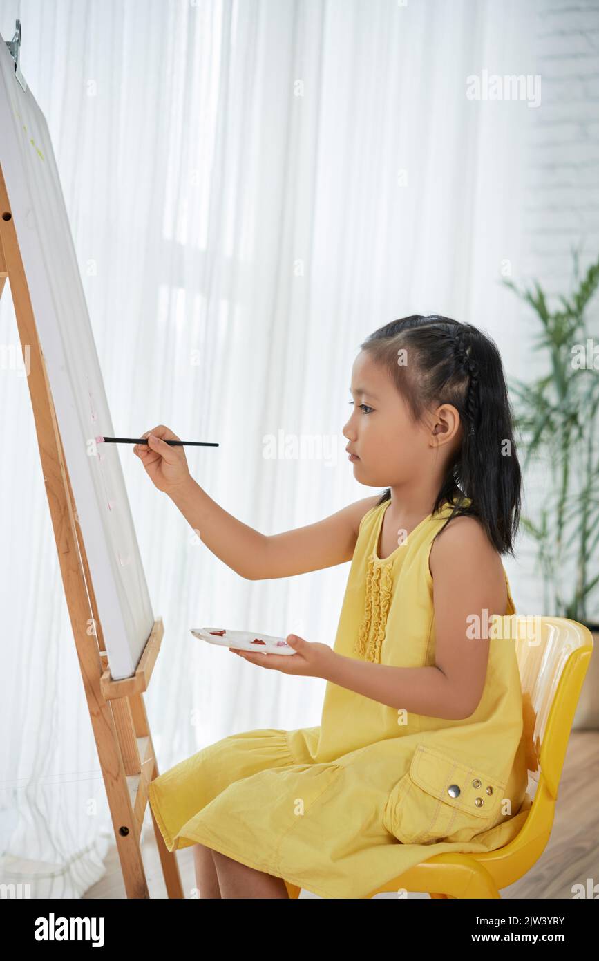 Talented little Vietnamese girl working on her first masterpiece Stock ...