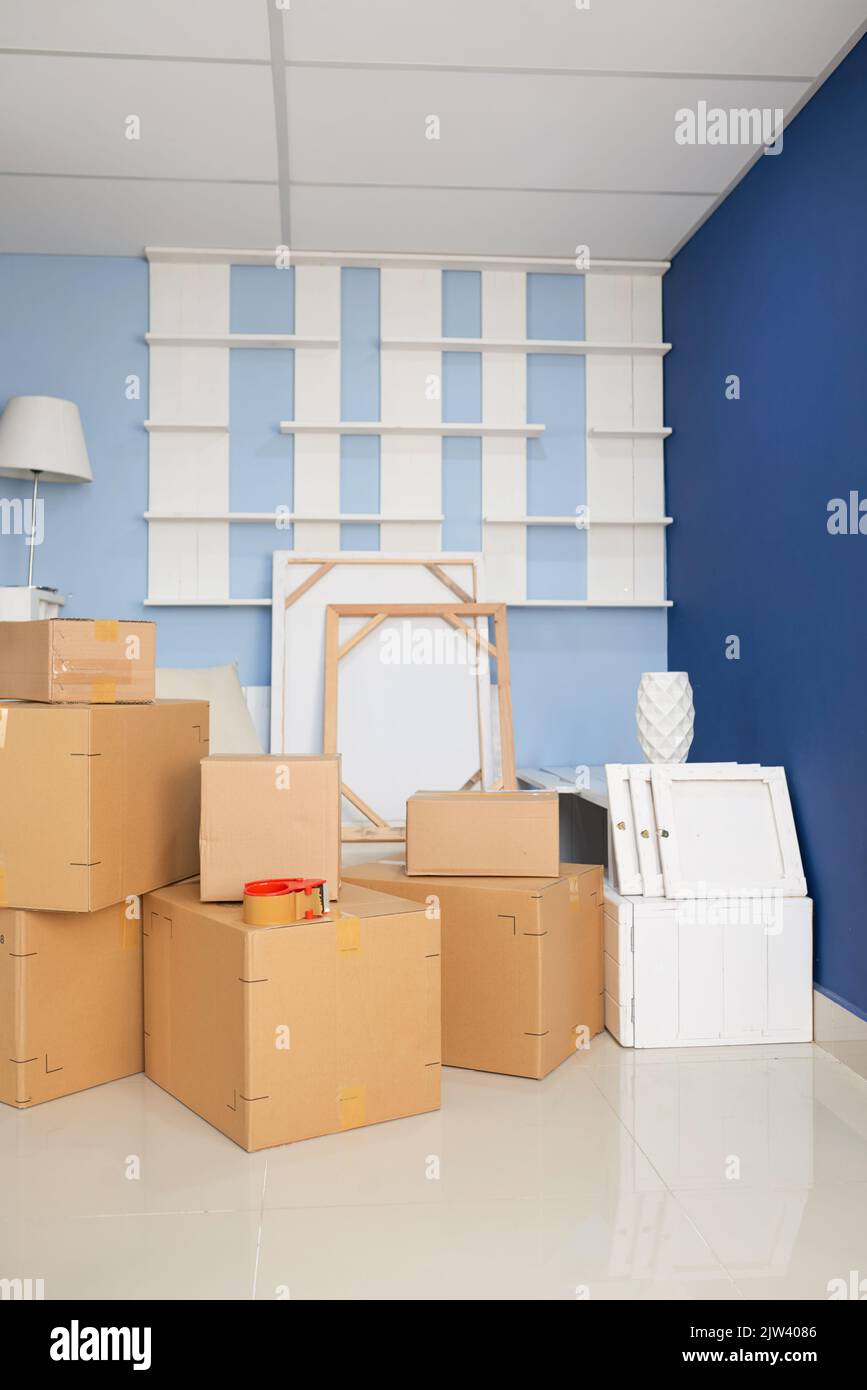 Packed cardboard boxes with domestic stuff stacked on the floor in ...
