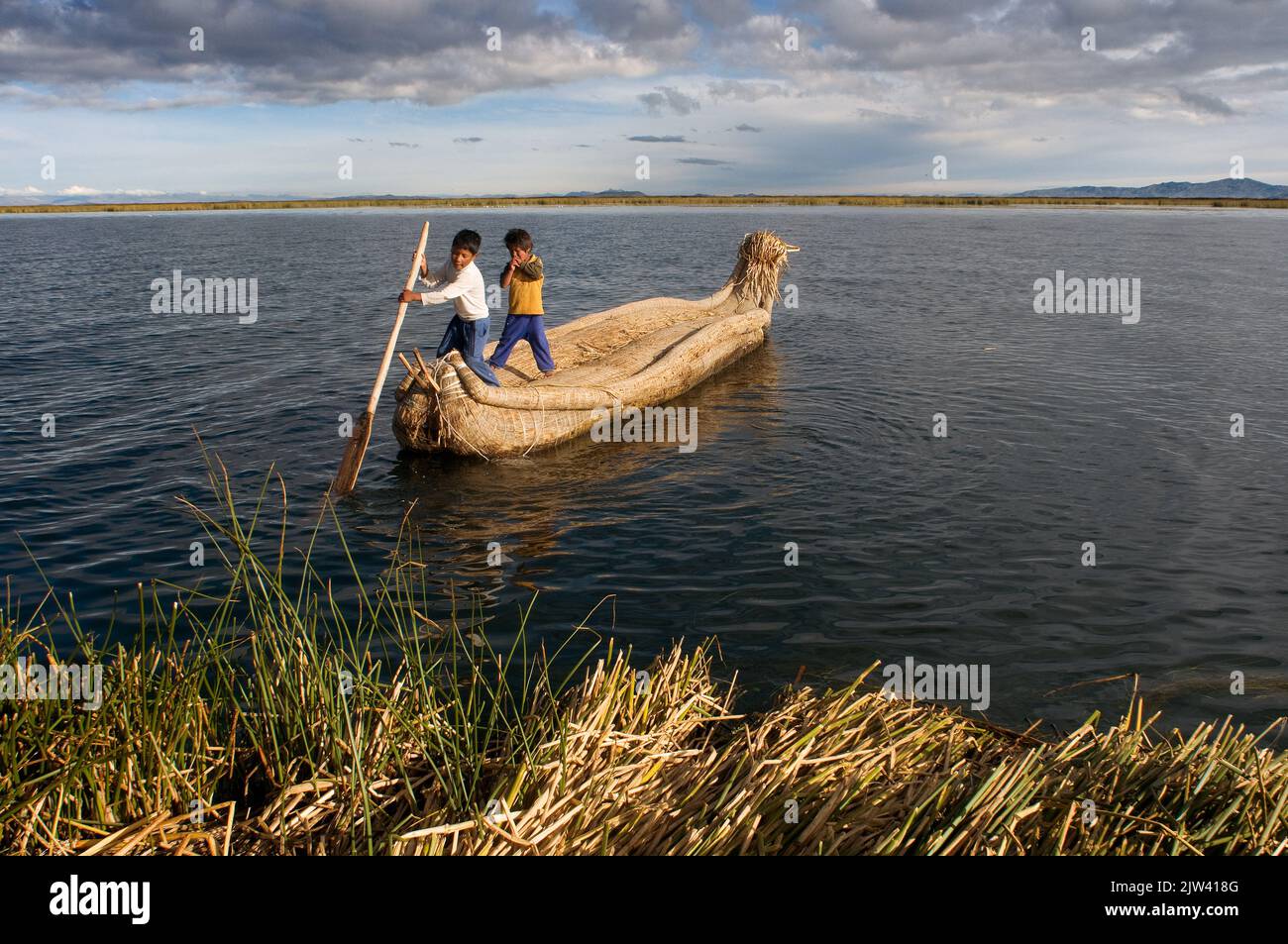Uros Island, Lake Titicaca, peru, South America. Children sail in a ...