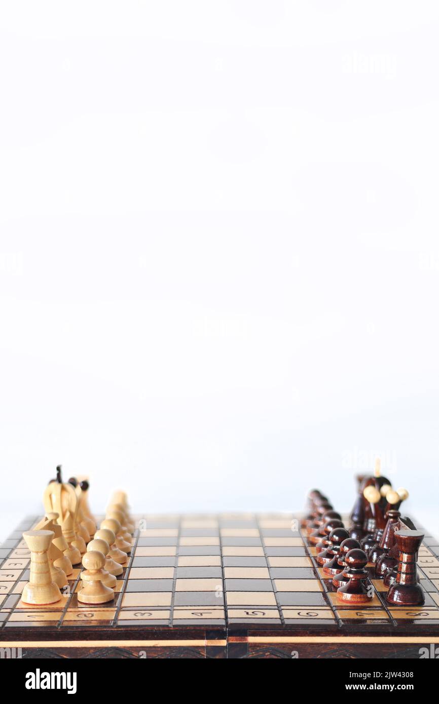 Black and white chess pieces arranged on chess board before start of ...