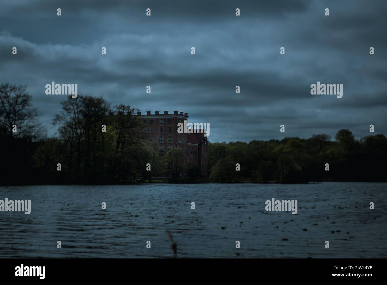 Dark and moody view of castle Svaneholms slott embedded in forest ...