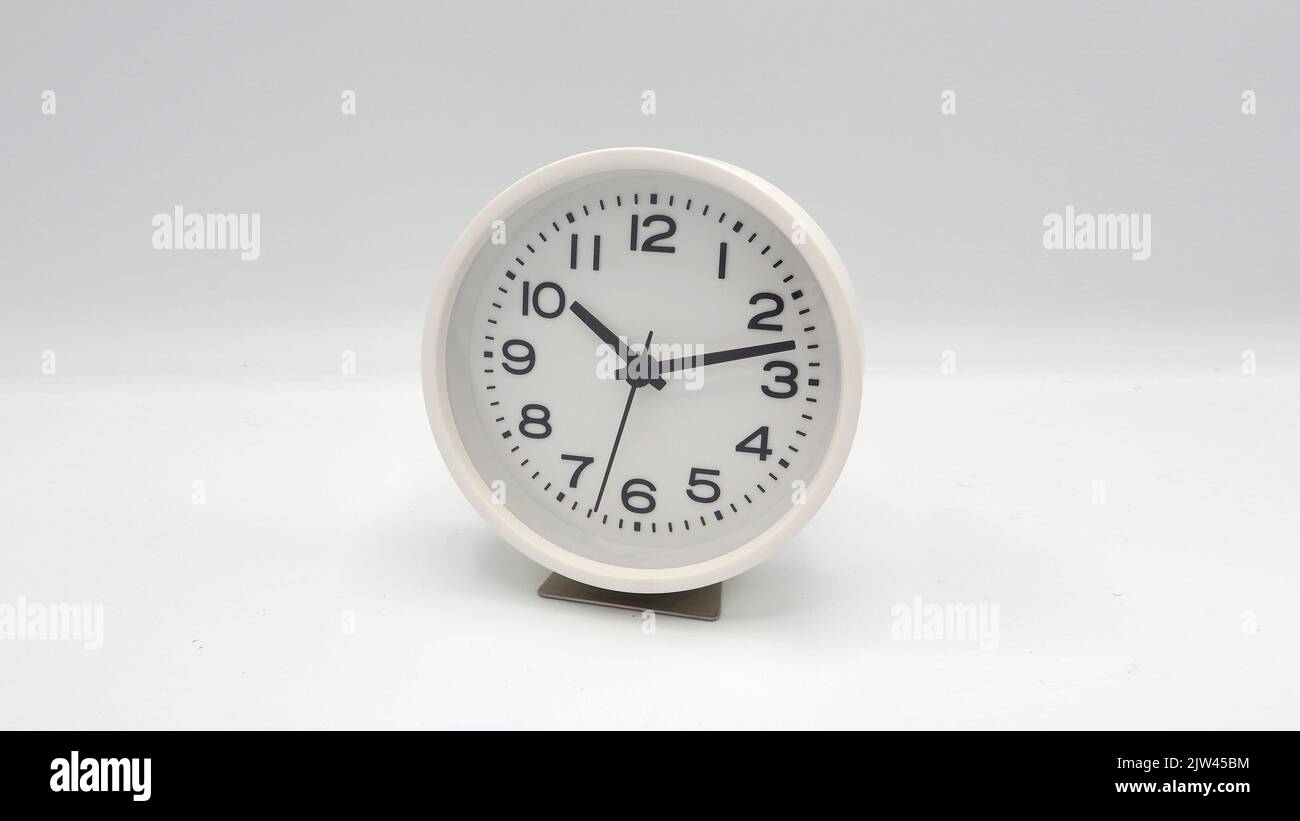 Modern and clean white color clock with minute hand and hour hand on ...