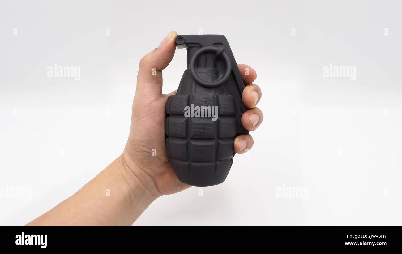 Man hand and military bomb plastic model toy and white background Stock ...