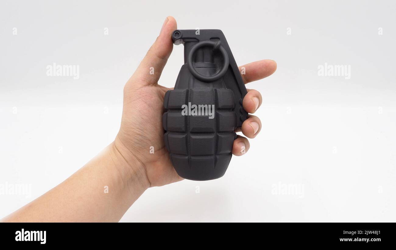 Man hand and military bomb plastic model toy and white background Stock ...