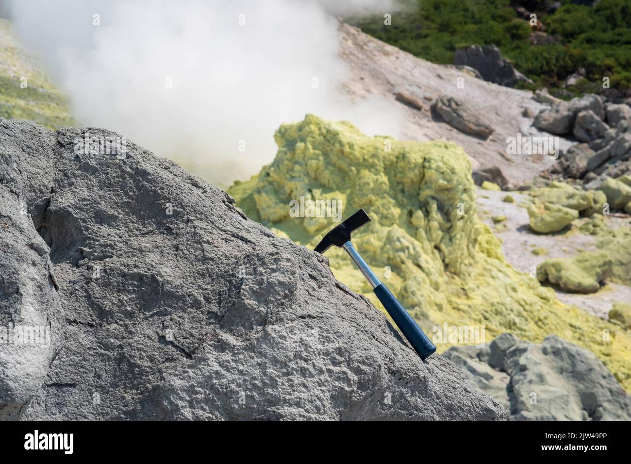 geological hammer in the rock against the backdrop of an steaming ...