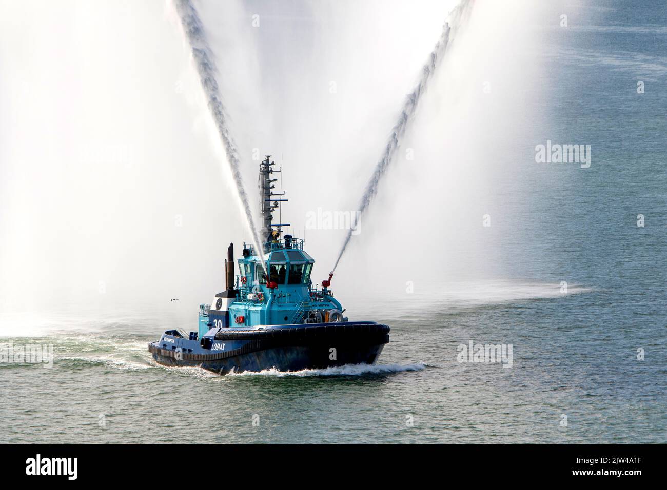 Lomax Fire Fighting Vessel tug water saluting cruise ship Stock Photo ...