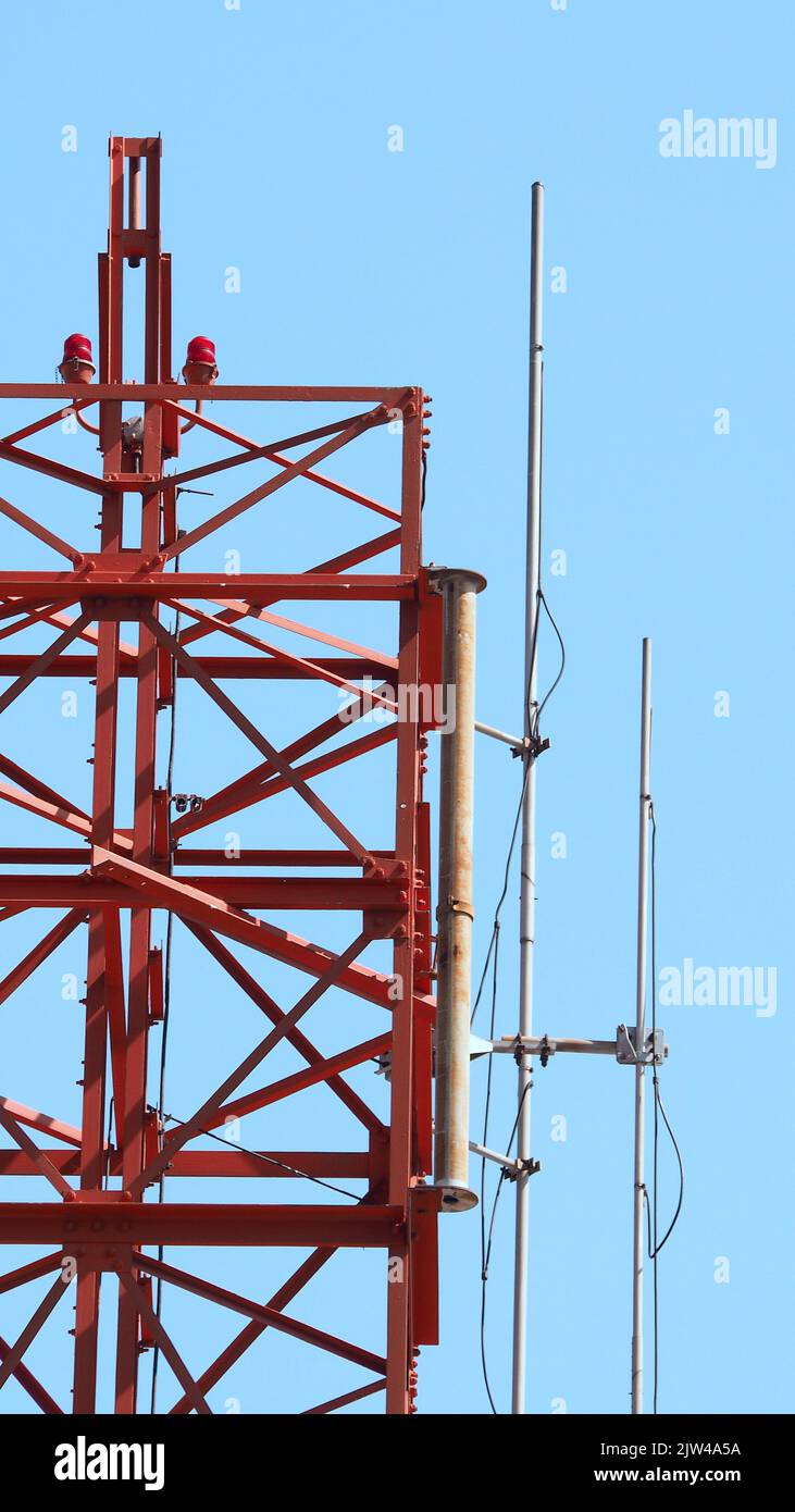 Telecommunication tower and red color and blue sky Stock Photo - Alamy