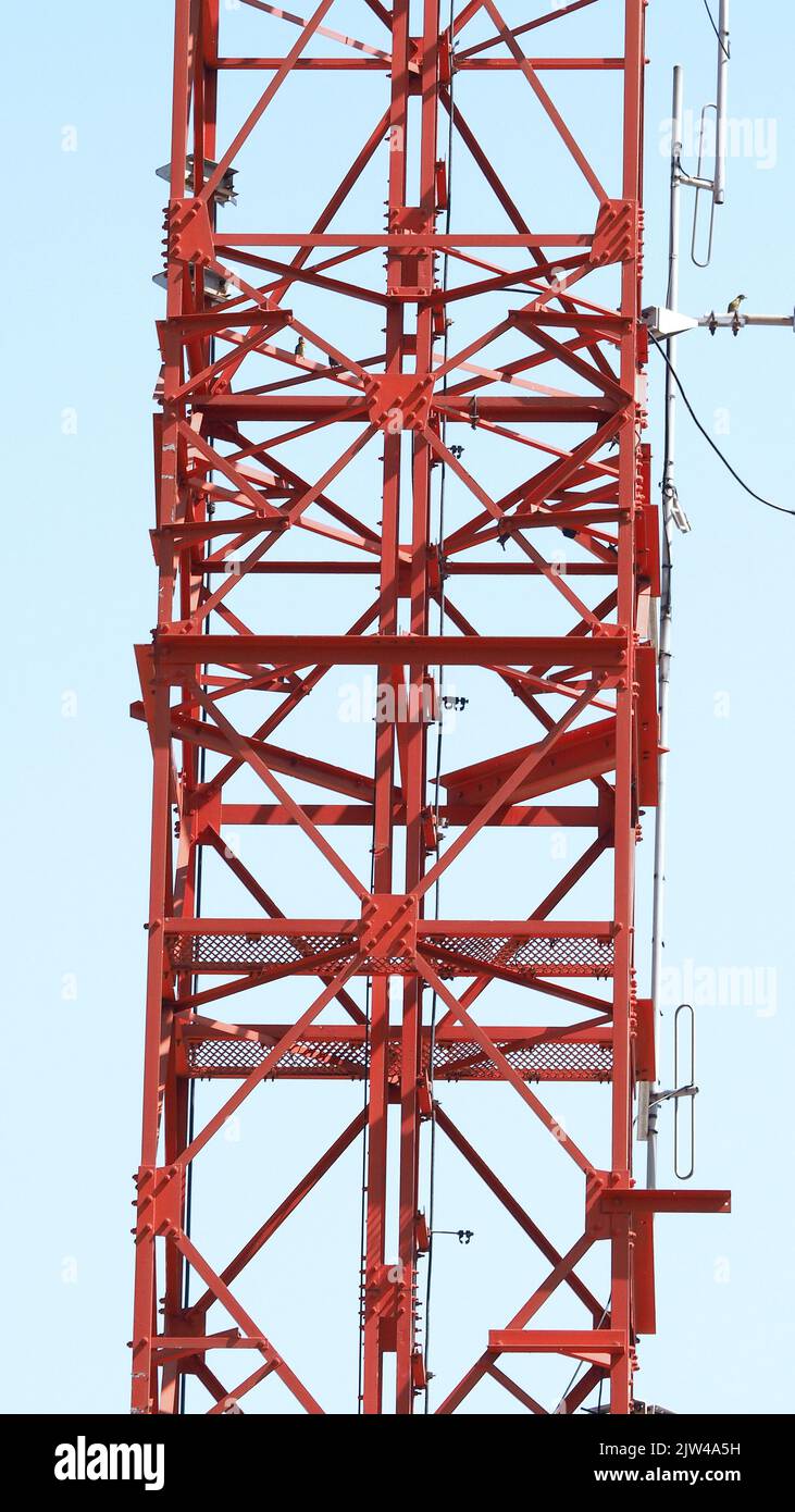 Telecom tower closeup with red color and blue sky Stock Photo - Alamy