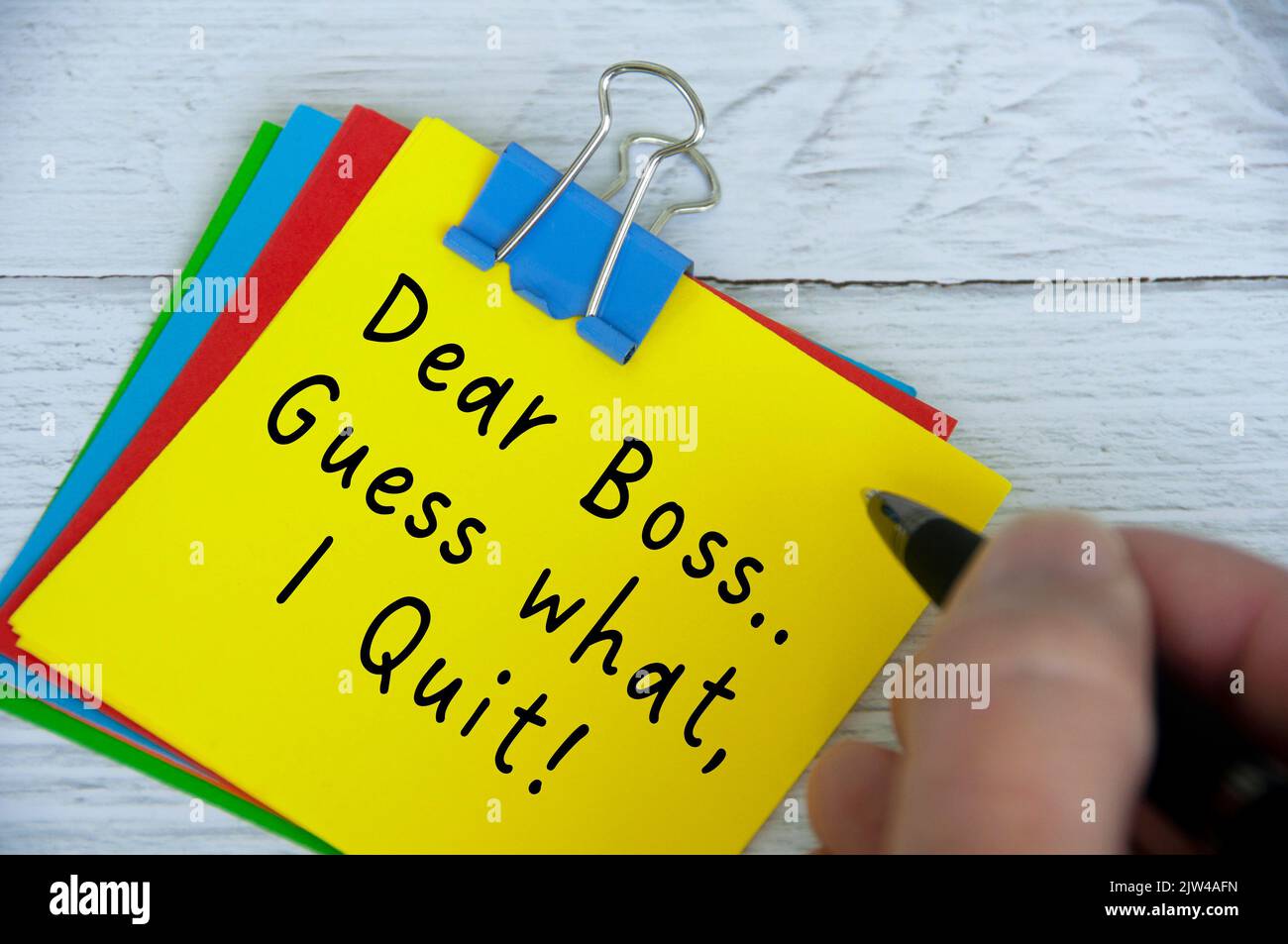 Dear boss, guess what, I quit text on yellow notepad on wooden desk ...