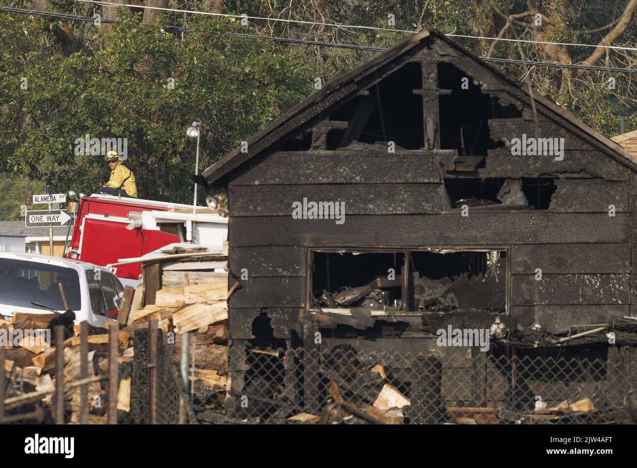Weed, United States. 23rd Aug, 2022. A fire fighter stands watches over ...