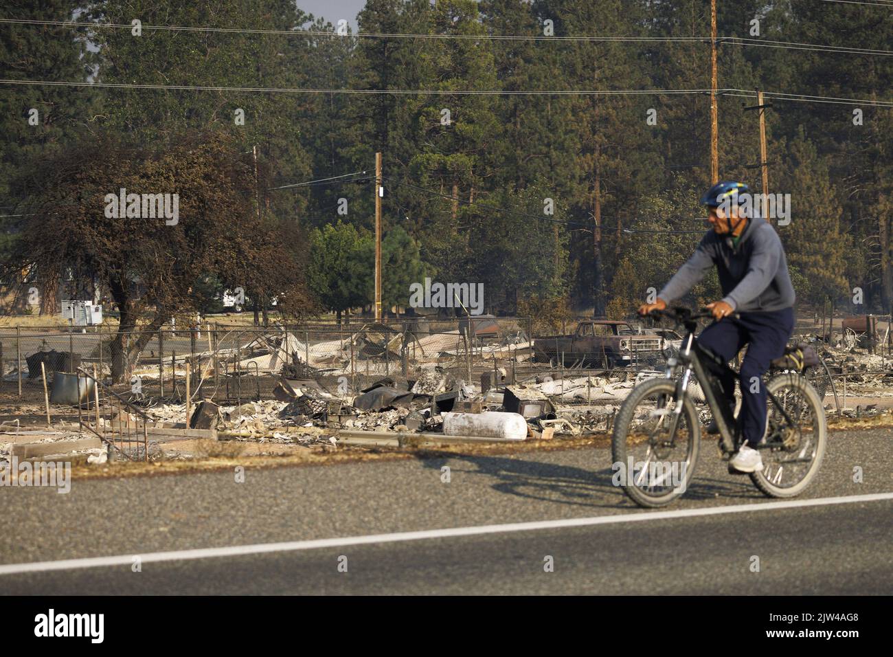 Weed, United States. 23rd Aug, 2022. A local resident rides passed the ...