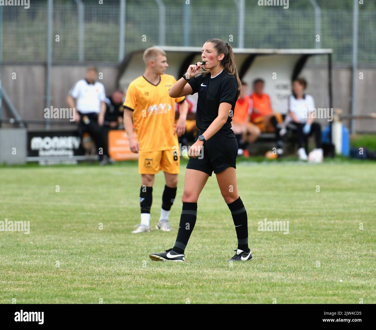A female referee officiating at the semi-professional football match ...