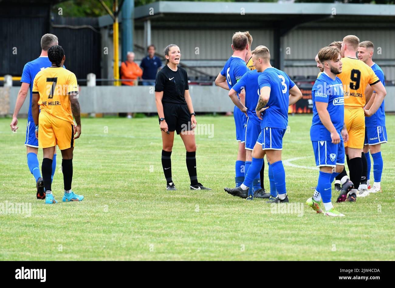 A female referee officiating at the semi-professional football match ...