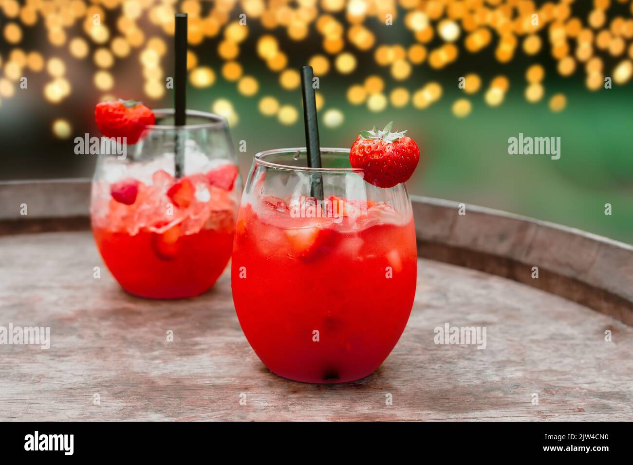Red strawberry daiquiri cocktail or mocktail in glass with drinking ...