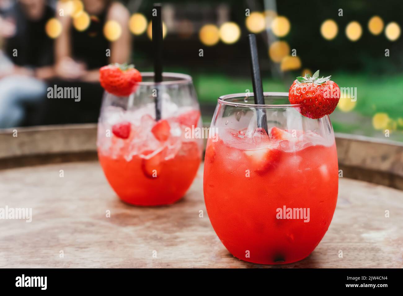 Red strawberry daiquiri cocktail or mocktail in glass with drinking ...