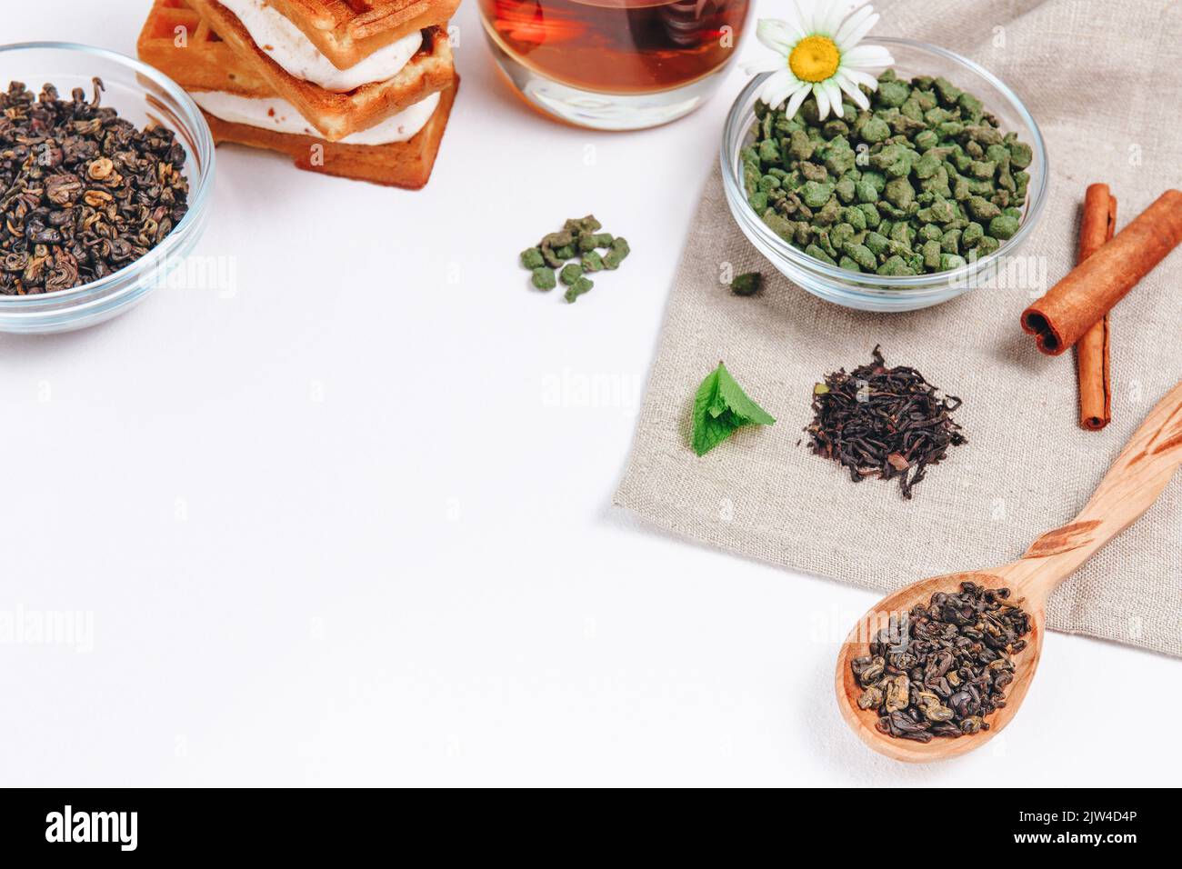 Fresh harvest of tea leaves on white background, top view, copy space ...