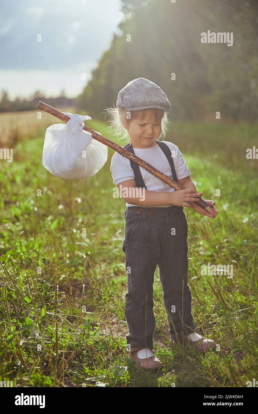 Beautiful sad street child in a field at sunset Stock Photo - Alamy
