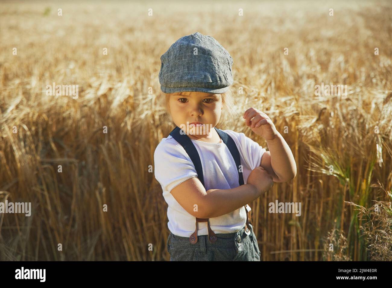 Adorable sad street child in a field at sunset Stock Photo - Alamy