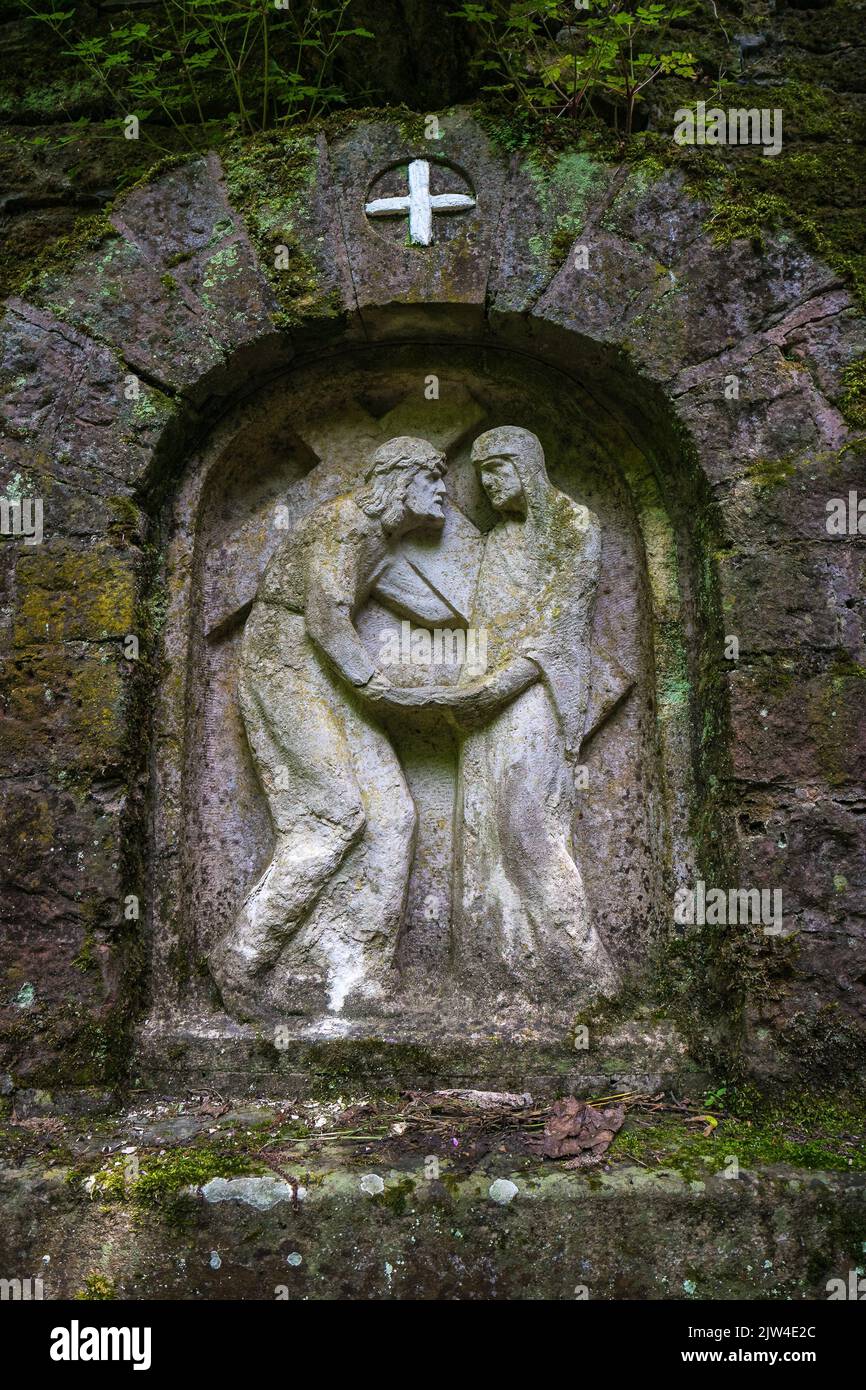 A vertical closeup shot of an old engraved sculptures of two Christian ...