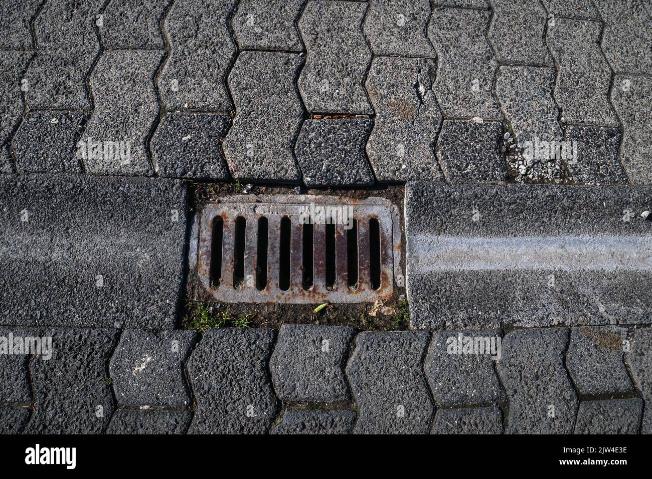 A closeup top view of a small rectangular manhole for rain water ...