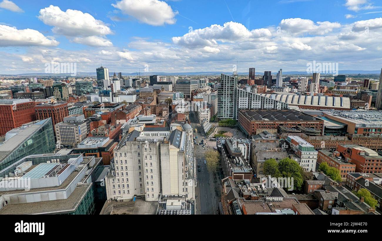 The cityscape of Manchester against the cloudy blue sky. England, UK ...