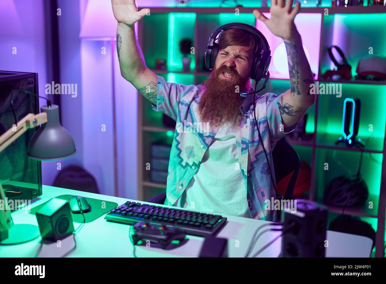 Young redhead man streamer stressed using computer at gaming room Stock ...