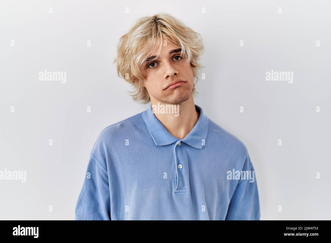 Young modern man standing over isolated background depressed and worry ...