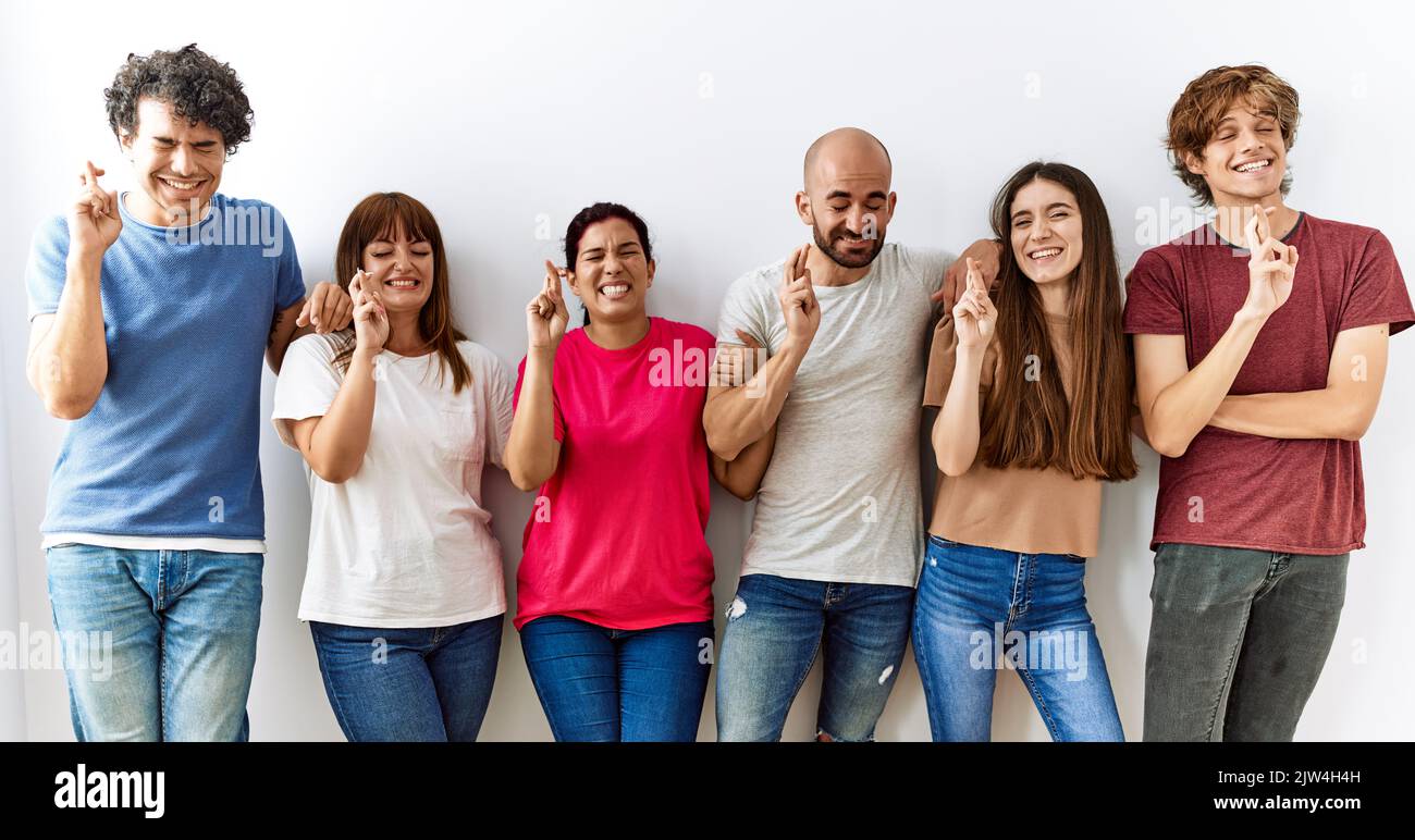 Group of young friends standing together over isolated background ...