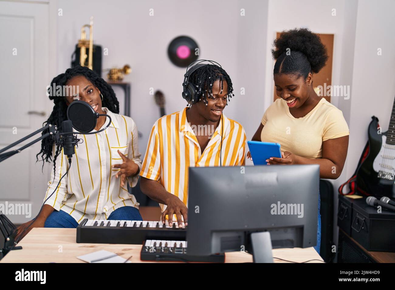 African american friends musicians group singing song using touchpad at ...
