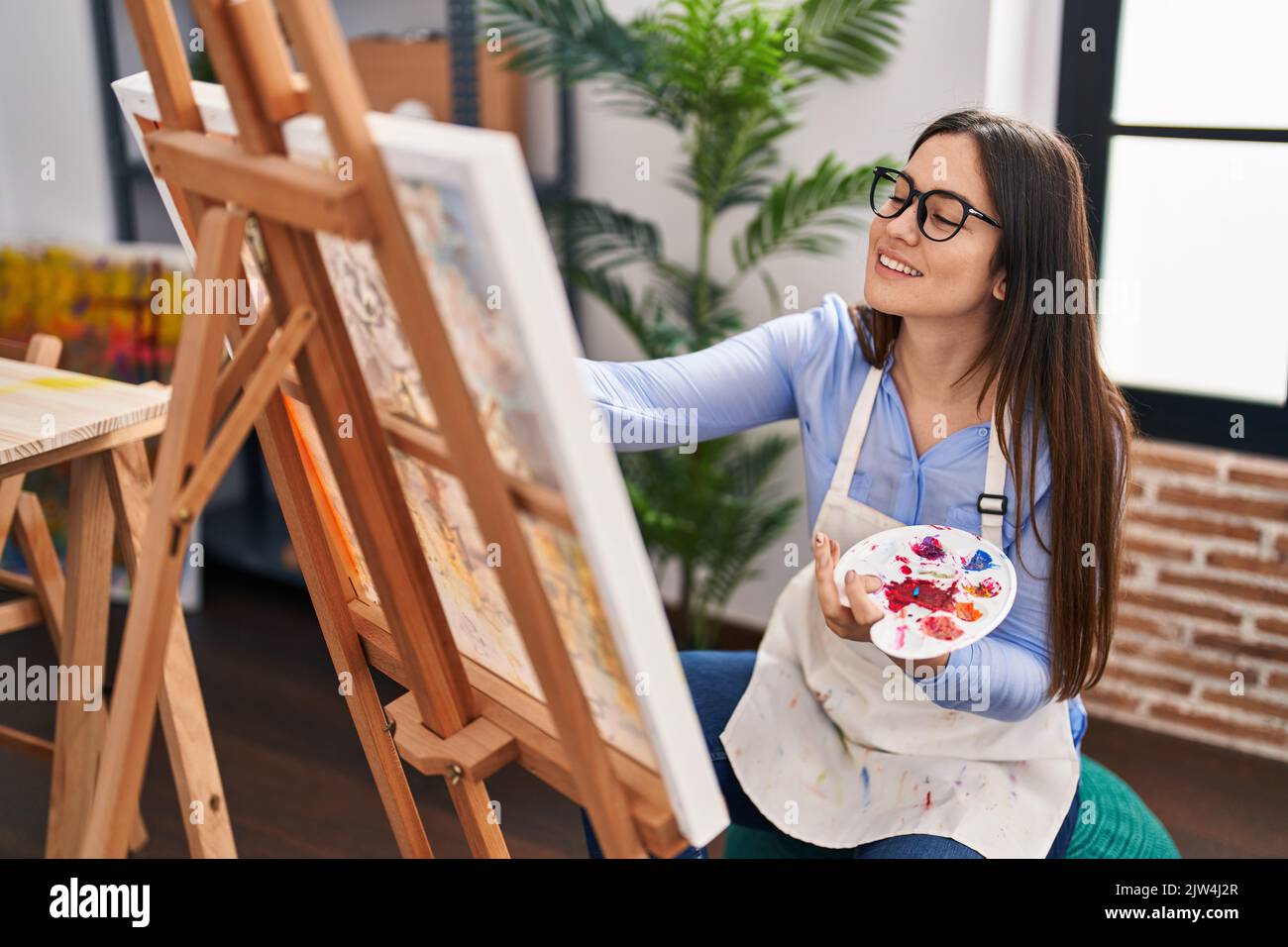 Young woman artist smiling confident drawing at art studio Stock Photo - Alamy
