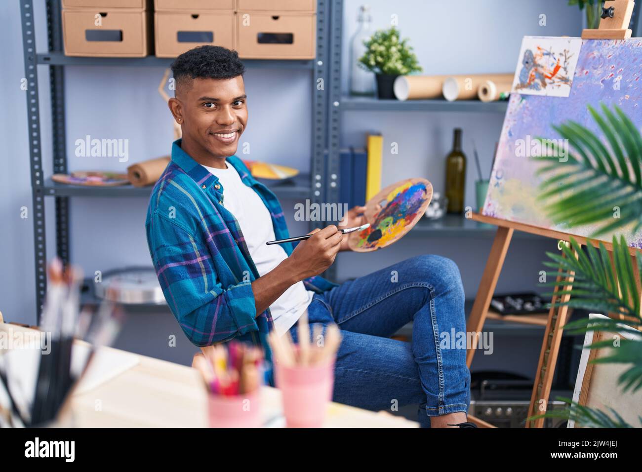 Young latin man artist smiling confident drawing at art studio Stock ...