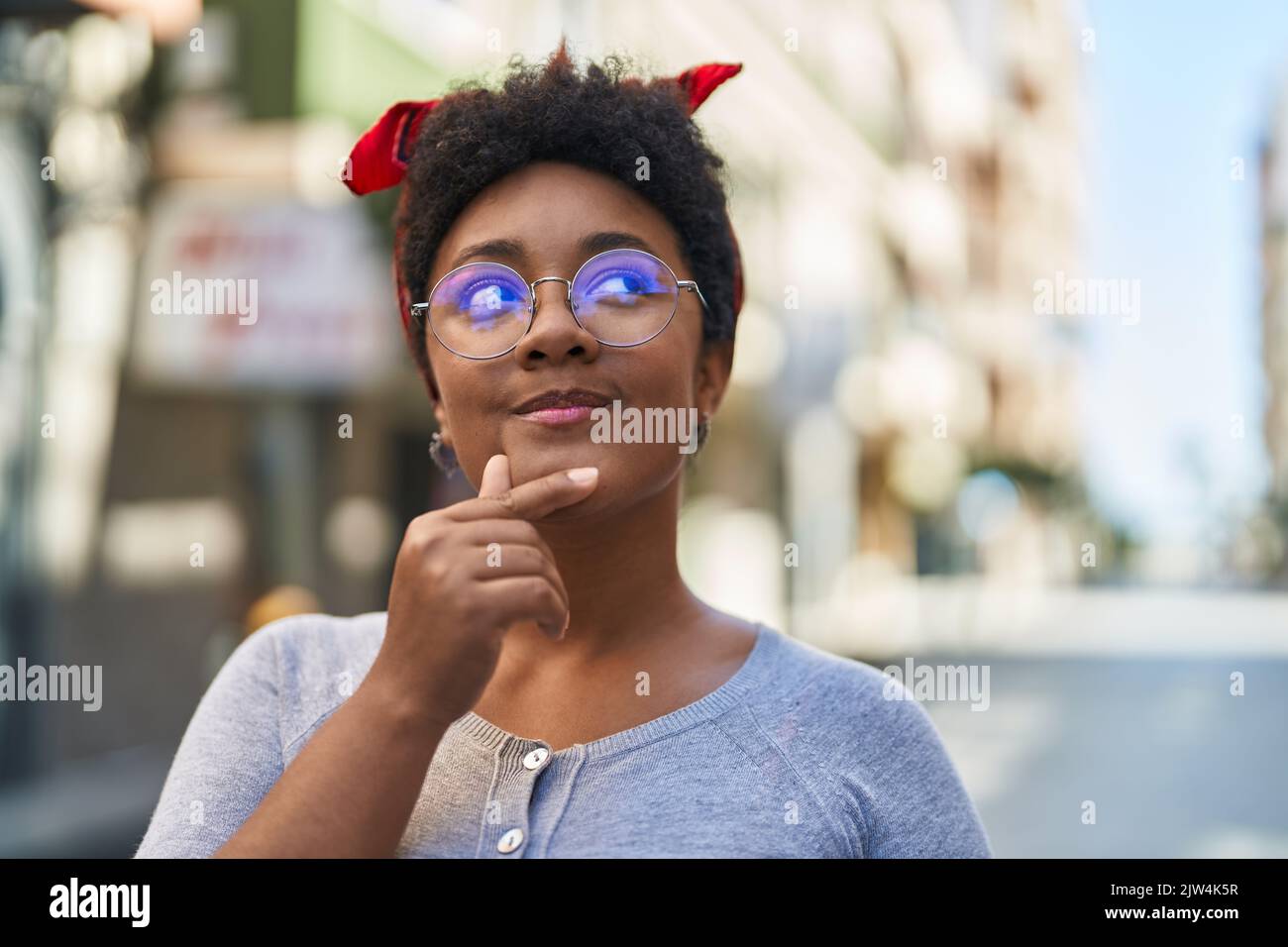 African american woman wearing glasses standing with doubt expression ...